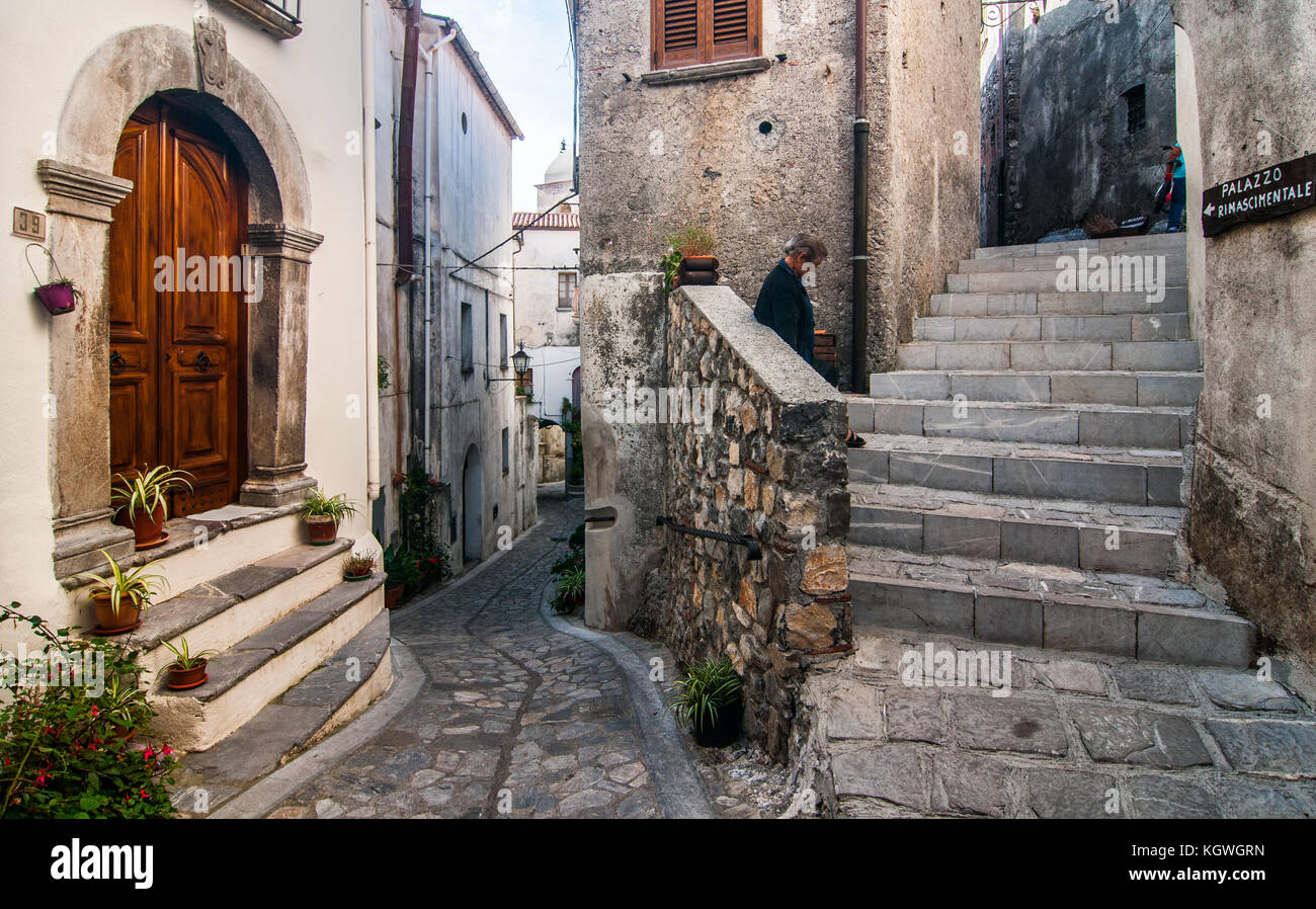 An old woman rests in the streets of the village of Aieta, Italy. Aieta ...