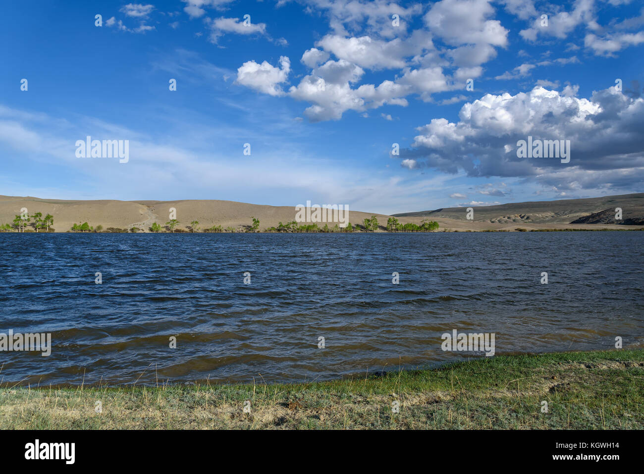Bright beautiful summer landscape with a lake, colored mountains, blue ...