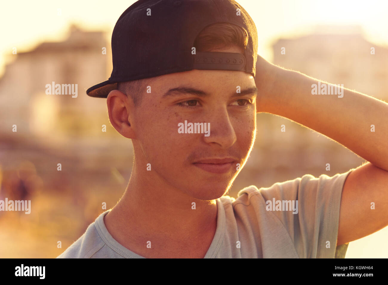 happy hipster boy with cap in sunset light Stock Photo - Alamy