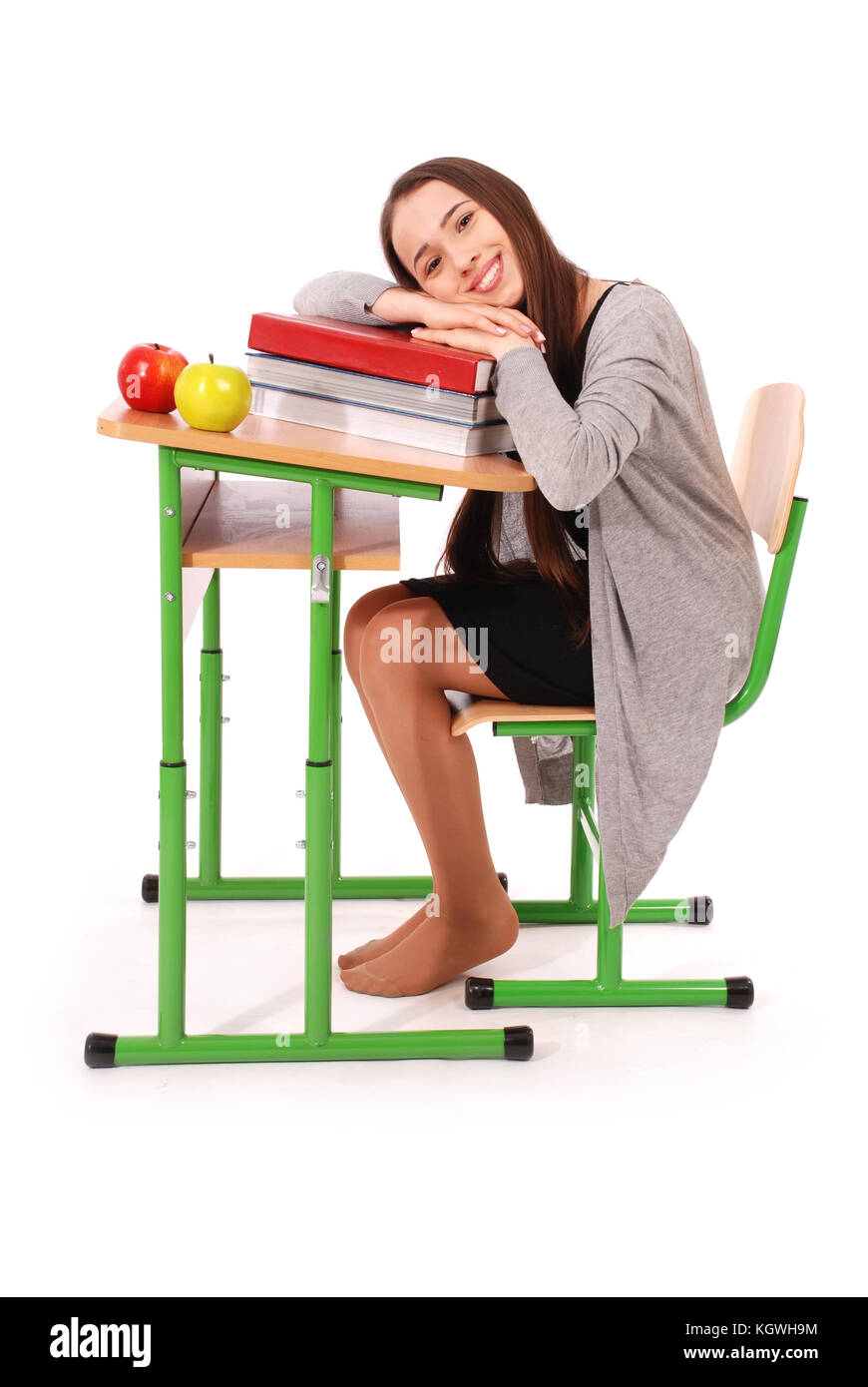 School girl sitting at a desk isolated on white Stock Photo - Alamy