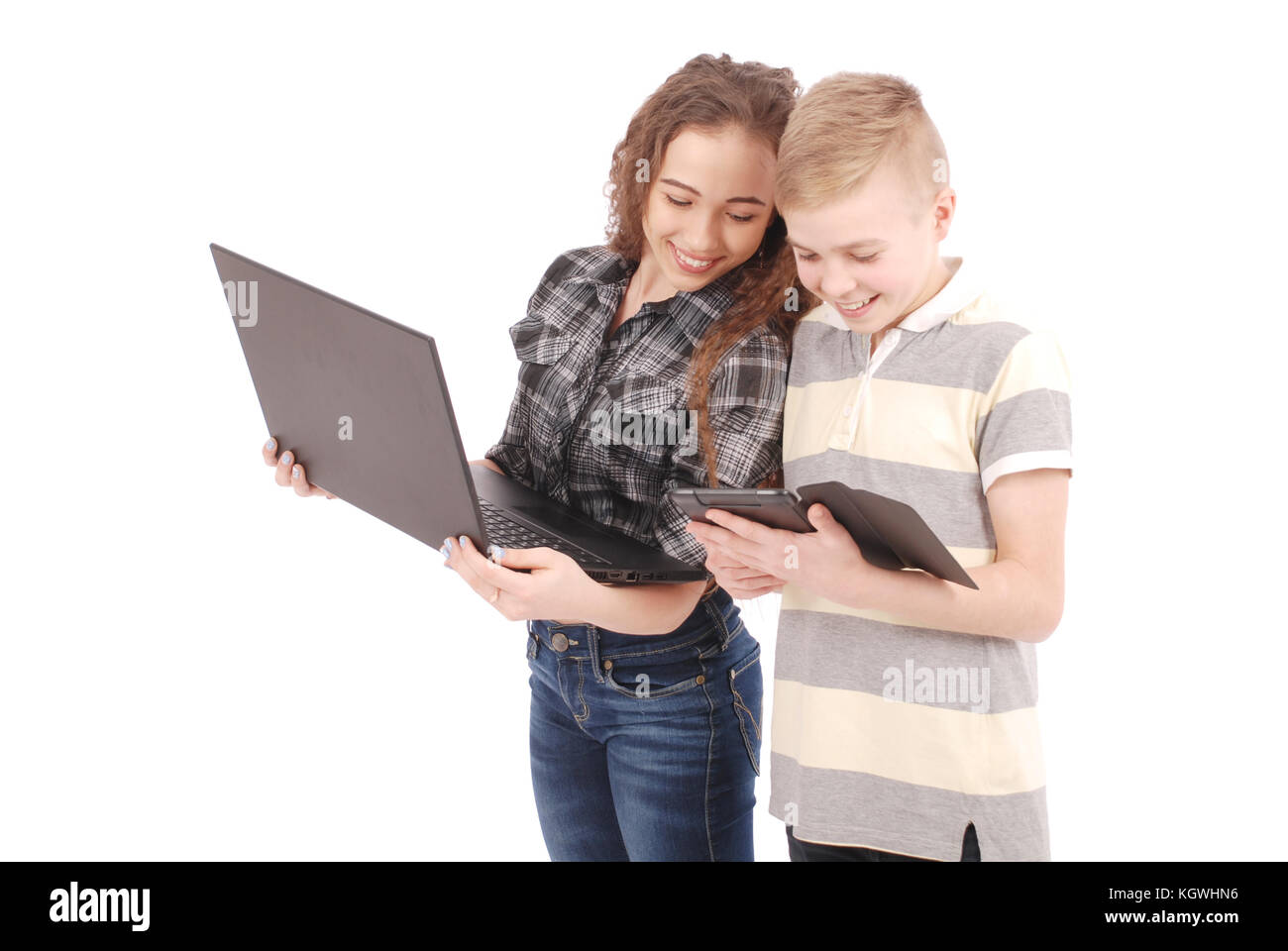 Two kids playing and surfing the web on digital tablet and laptop ...