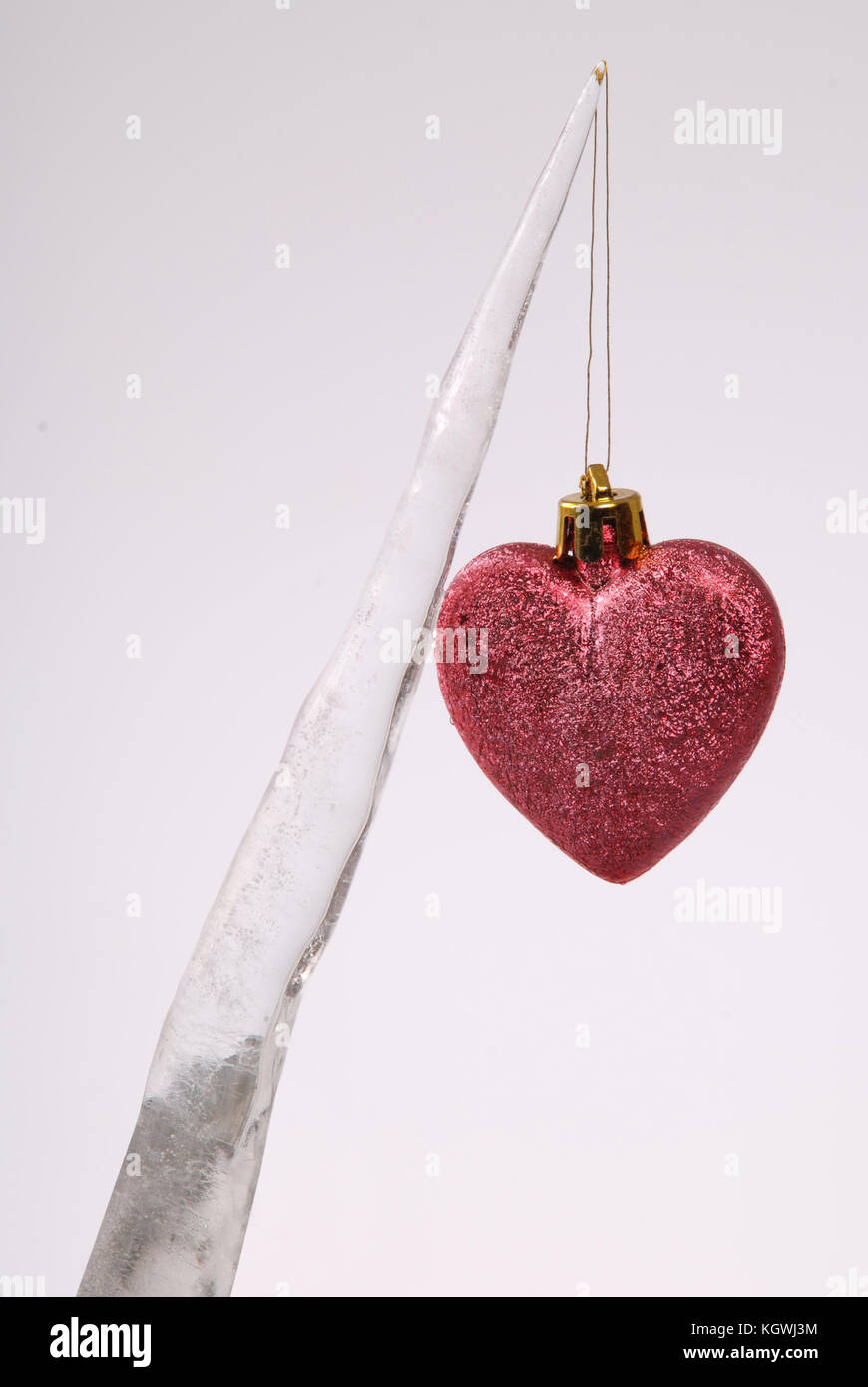 Icicle with a Christmas tree toy isolated on a grey background. Frozen ...