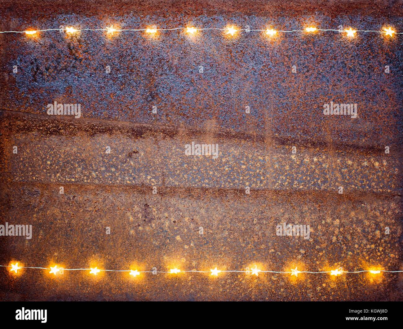 Rusty Christmas background. Xmas lights on rusty iron Stock Photo - Alamy