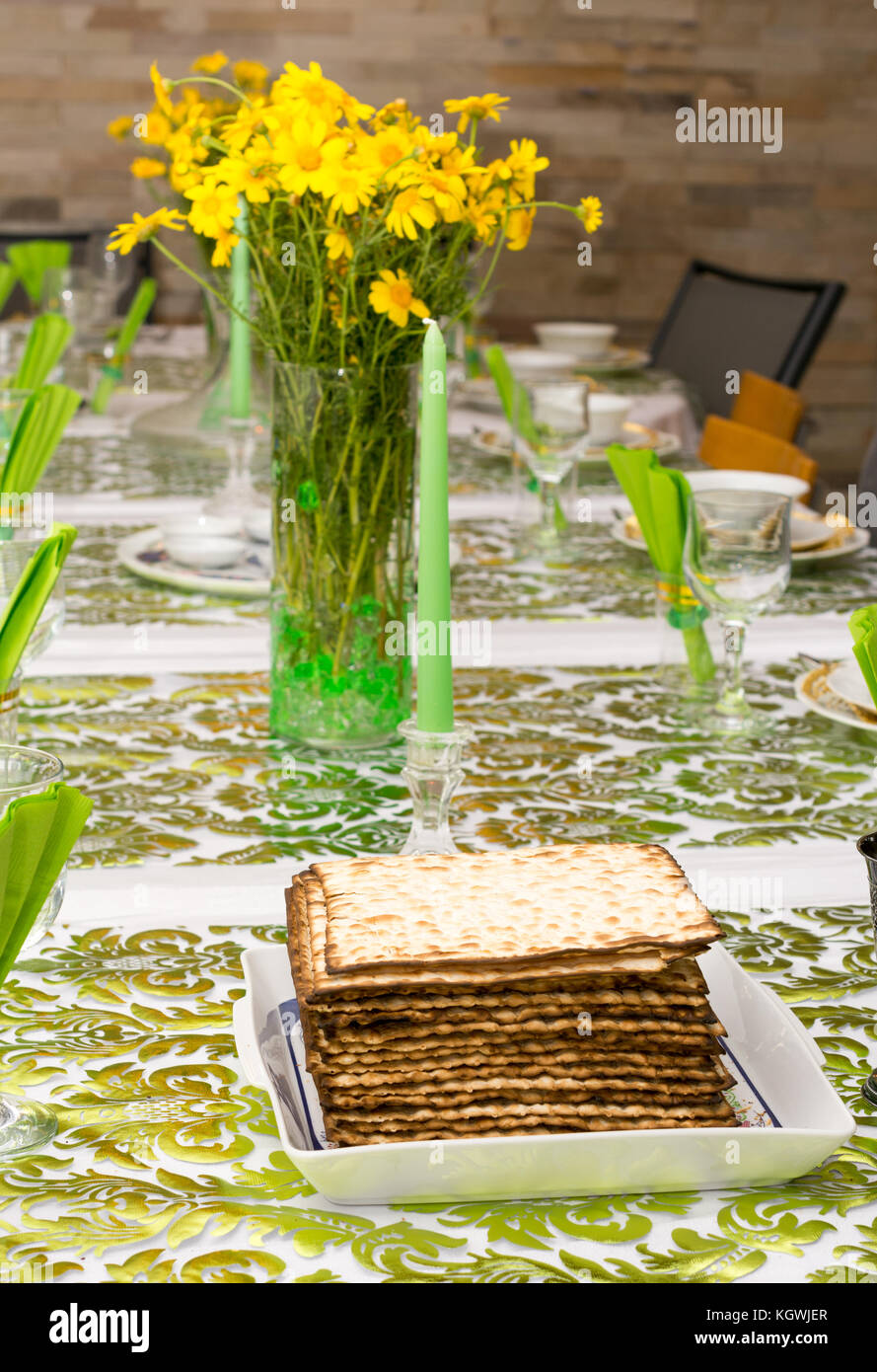 Matzos on a Modern Passover Seder table with green and gold decorations ...