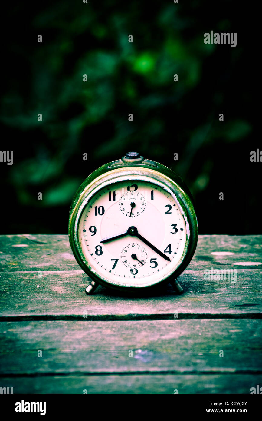 Old clock on wooden surface Stock Photo - Alamy