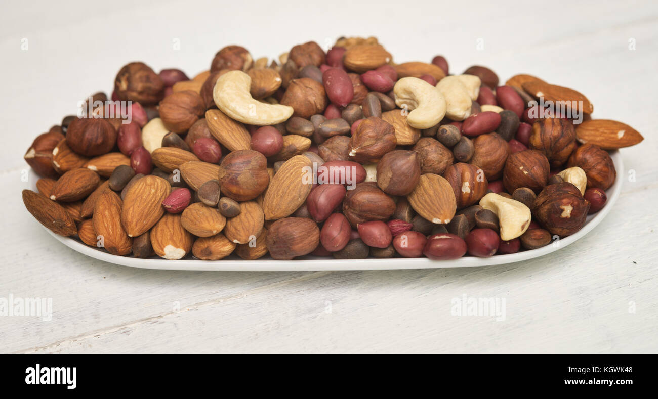 mixed nuts on a plate Stock Photo - Alamy