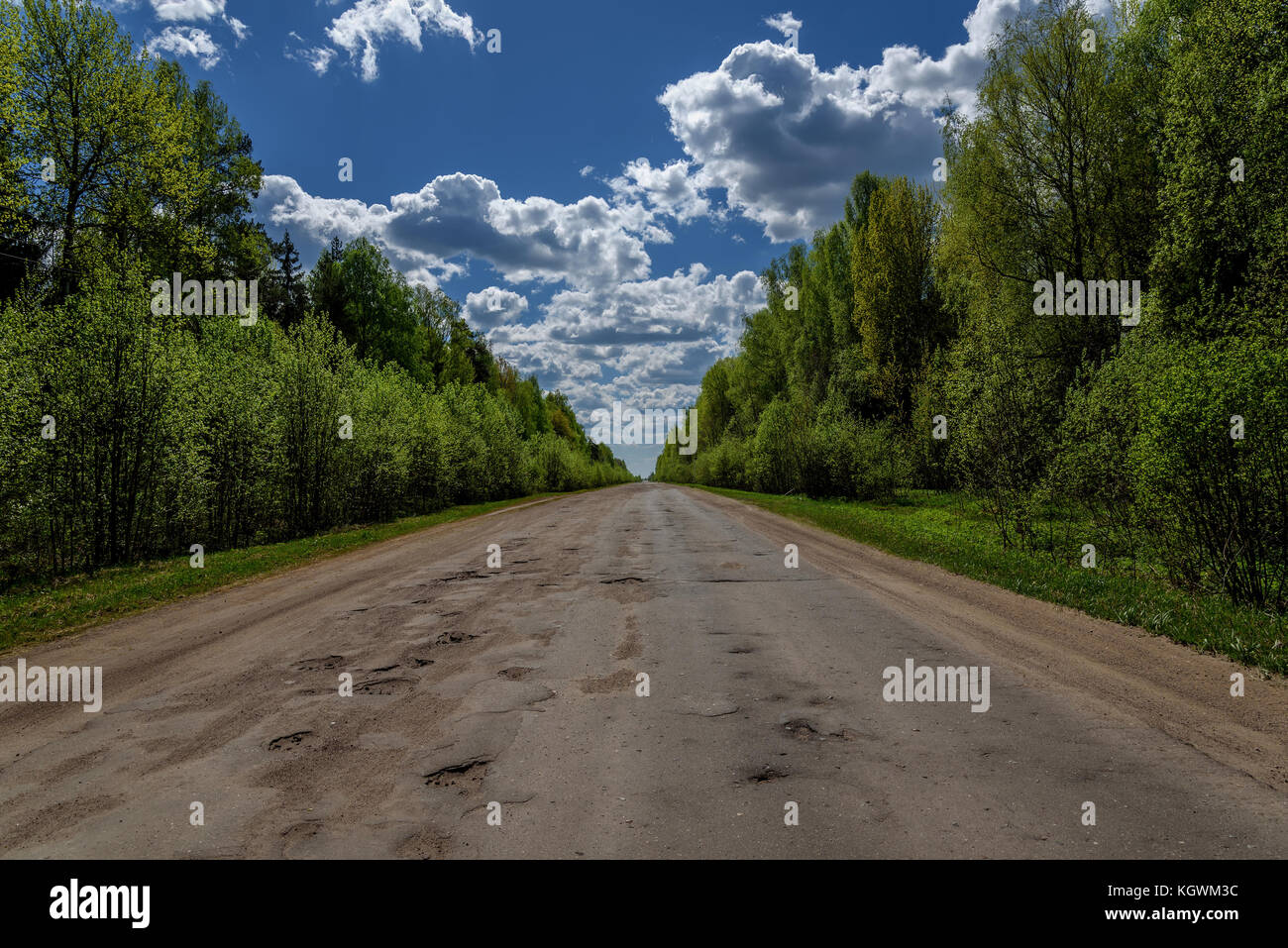 Scenic view of an asphalt road with holes and destroyed the road ...