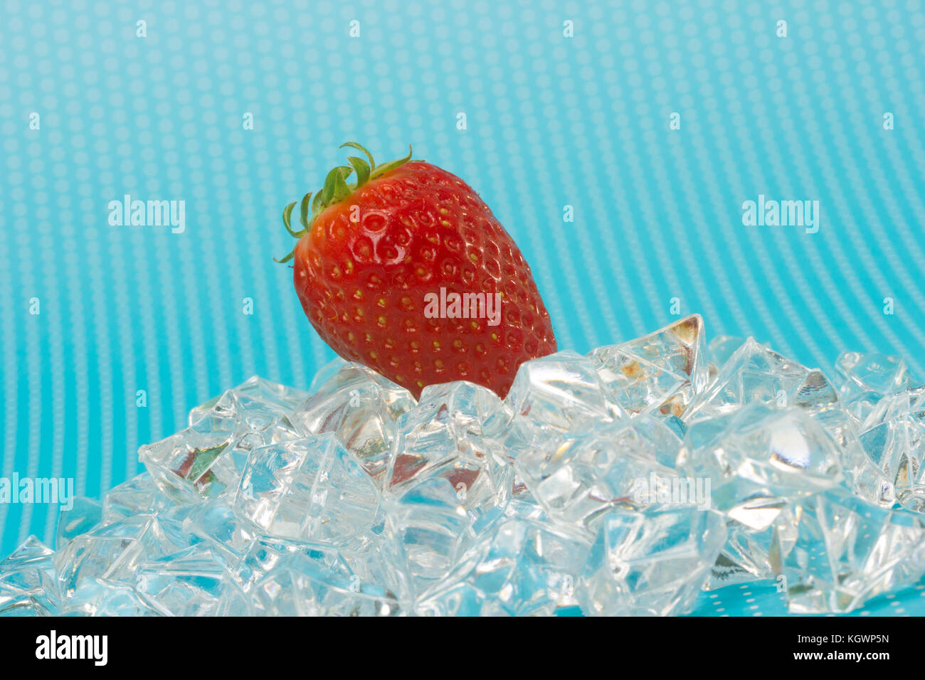 fresh strawberry on ice and blue background Stock Photo - Alamy