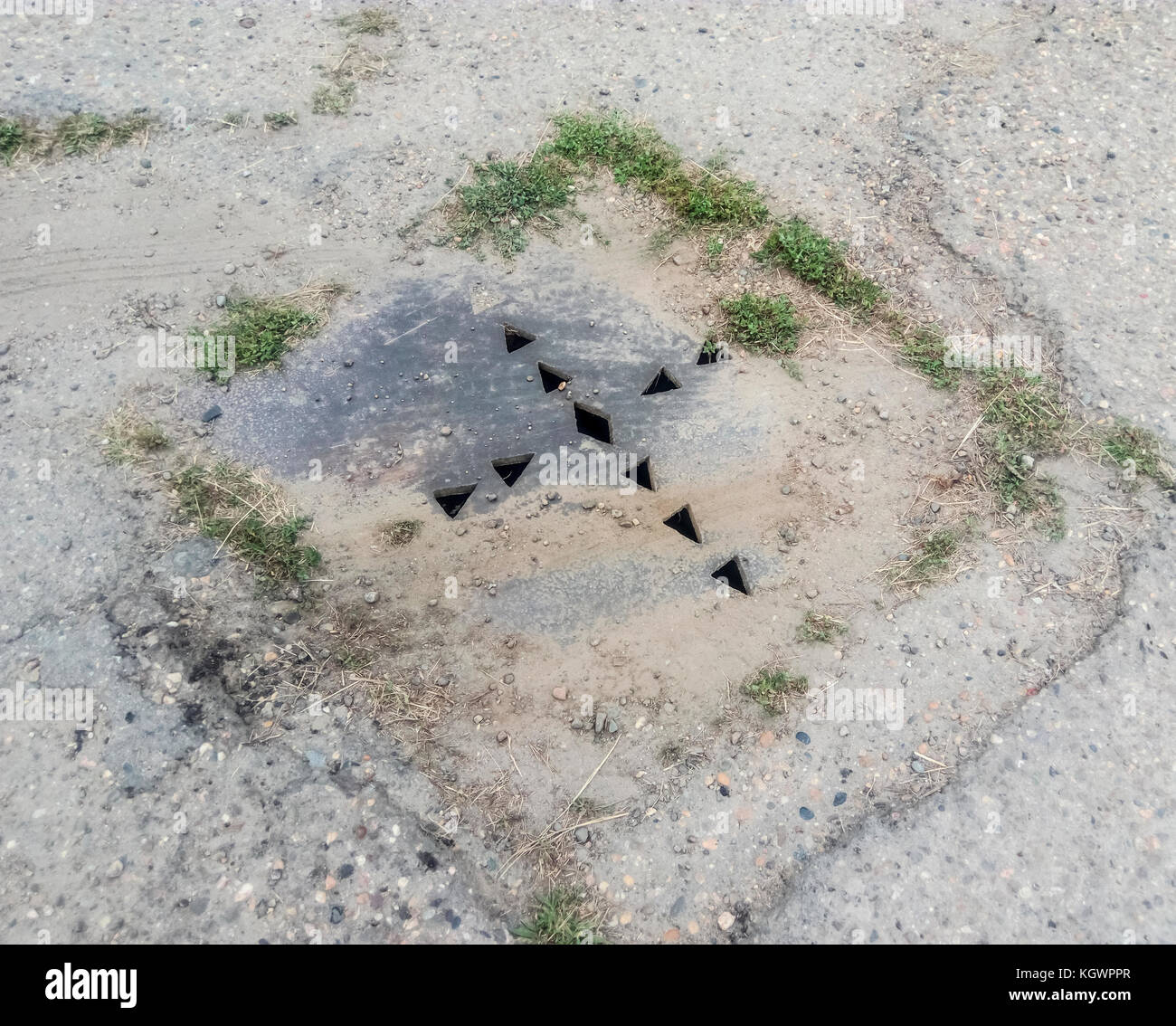 The drain hatch, amid the asphalt hatch with holes Stock Photo - Alamy