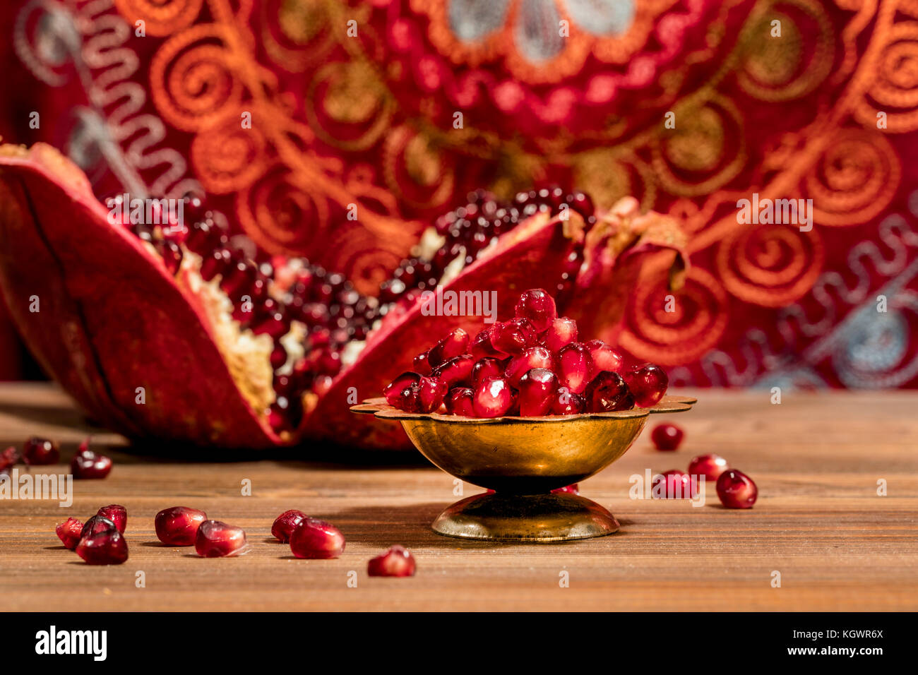 Ripe cracked grenade lies on the vintage dining table in a kitchen ...