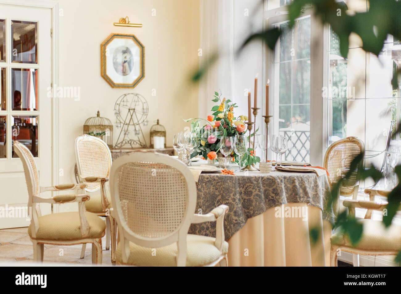 a dining table and comfortable armchairs in a modern house with a light ...