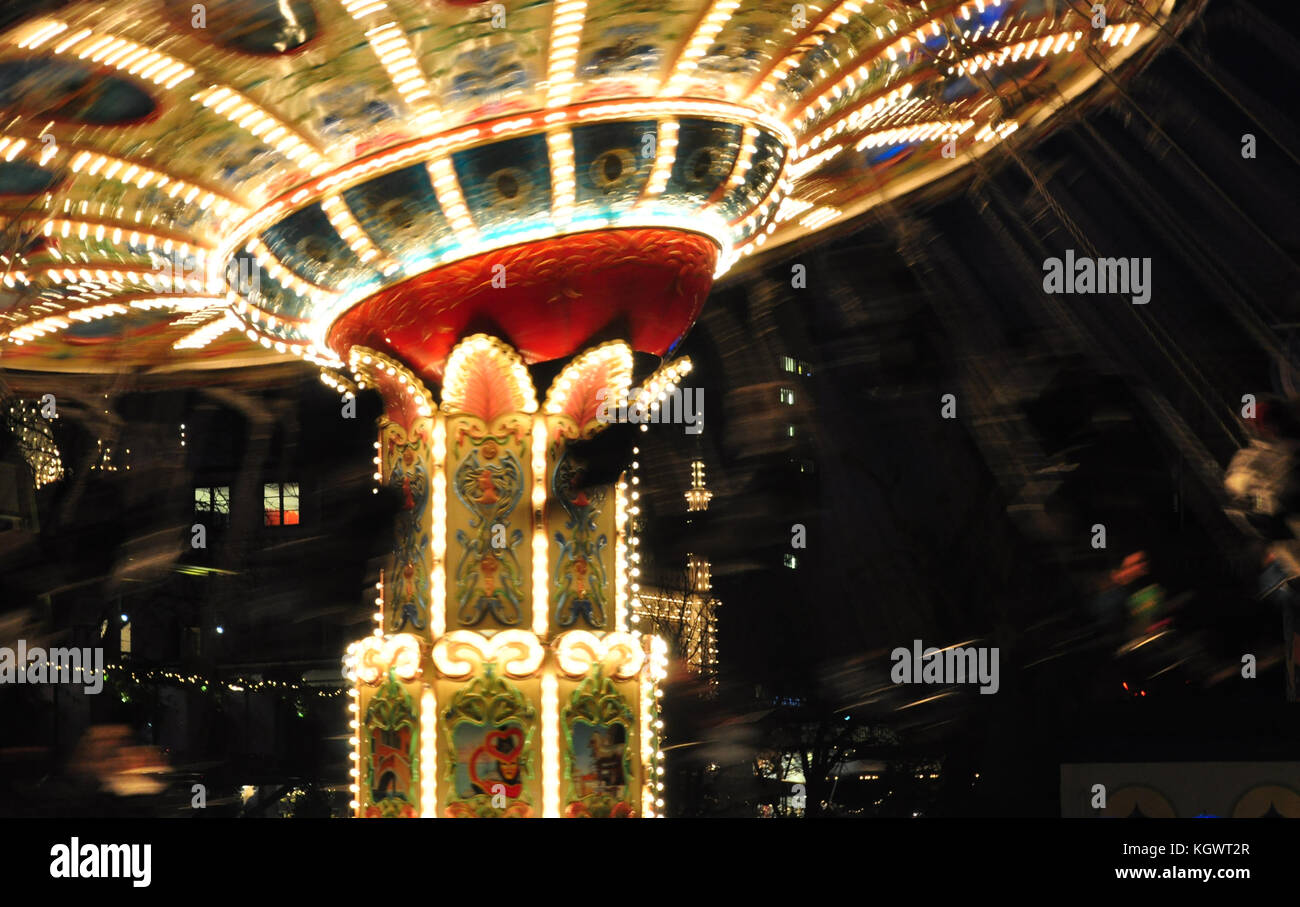 Spinning chain carousel at night Stock Photo - Alamy