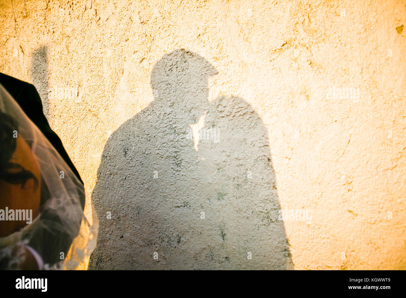 Shadow of groom and bride on yellow textured wall High Resolution Stock ...