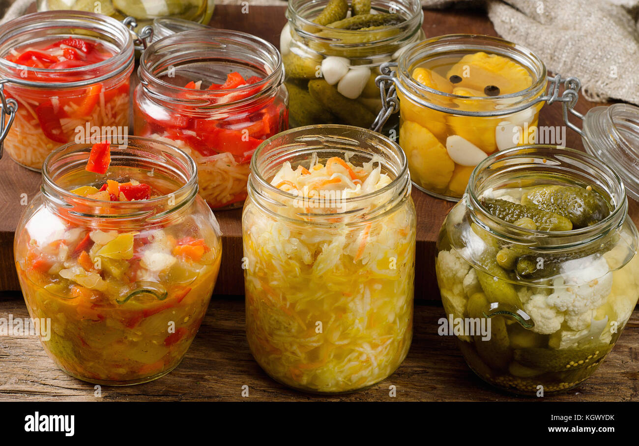 Homemade fermented preserved vegetables on a dark rustic background ...
