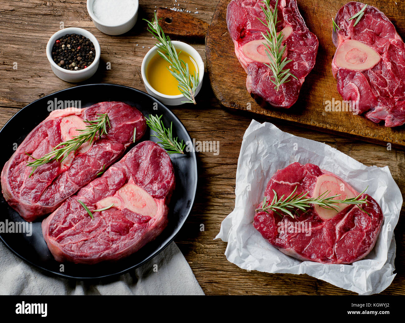 Raw beef meat cross cut for ossobuco cut on a board over rustic wooden ...