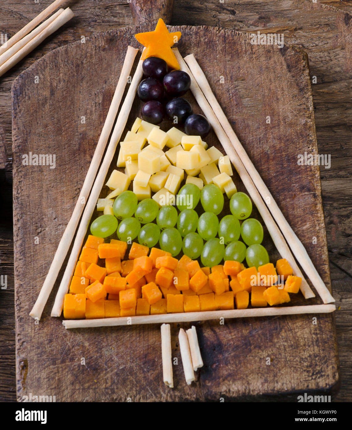 Christmas cheese and grape tree on rustic wooden board. Top view Stock ...