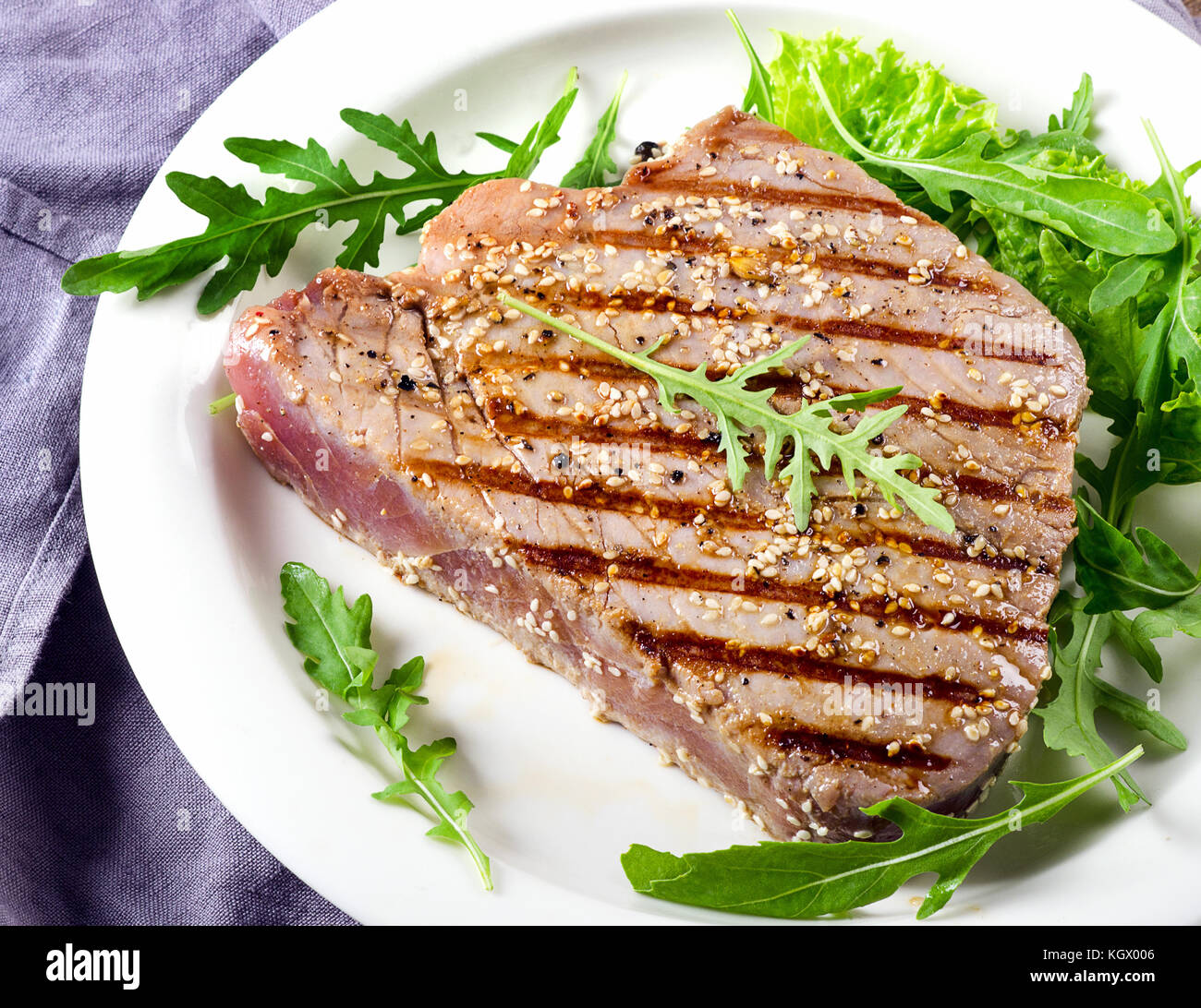Grilled tuna with fresh green salad leaves. Top view Stock Photo - Alamy