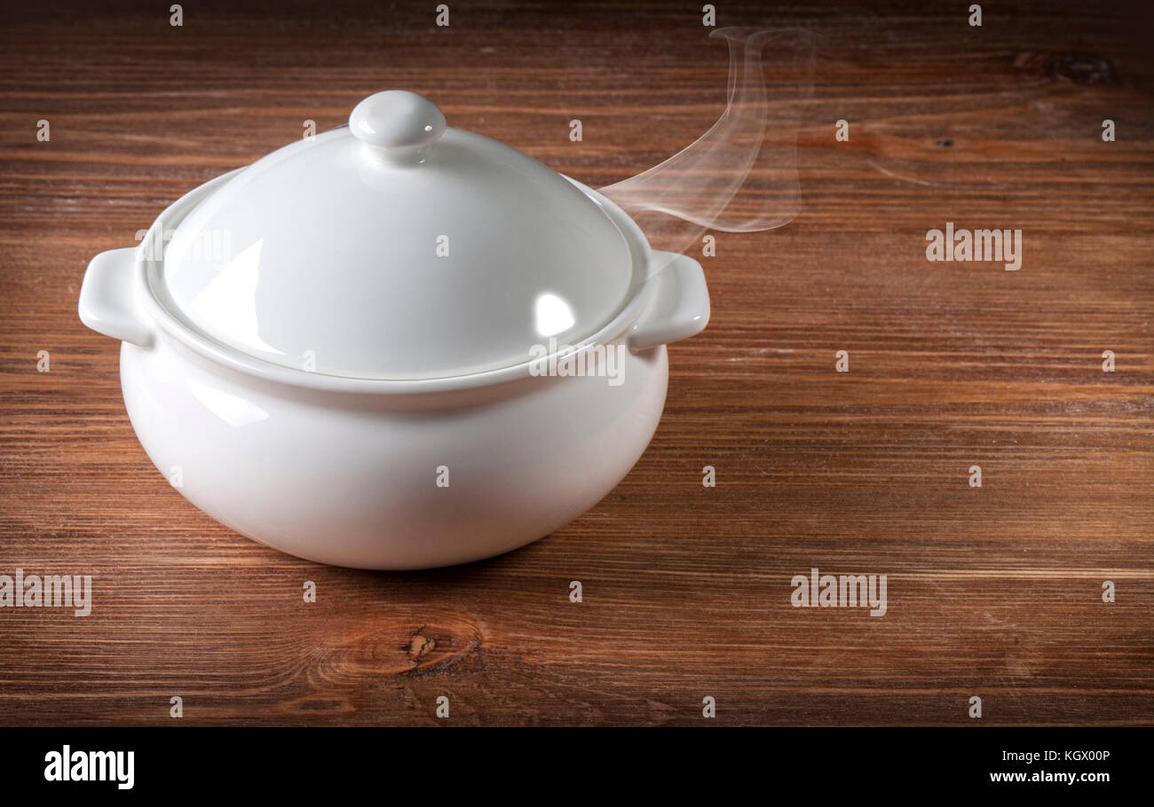cooking pot on old wooden table Stock Photo - Alamy
