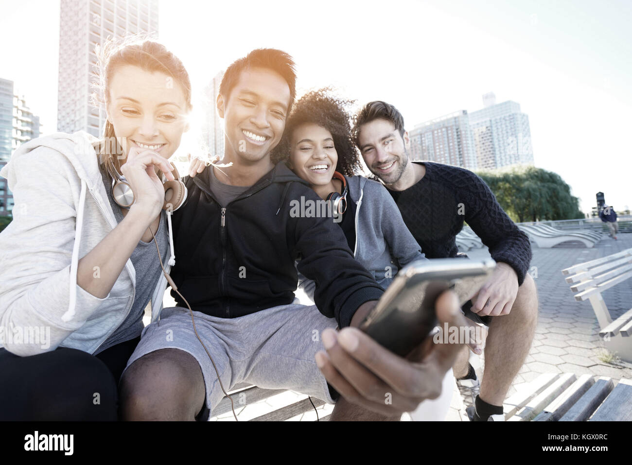 Group of friends in casual outfit taking selfie picture with smartphone ...