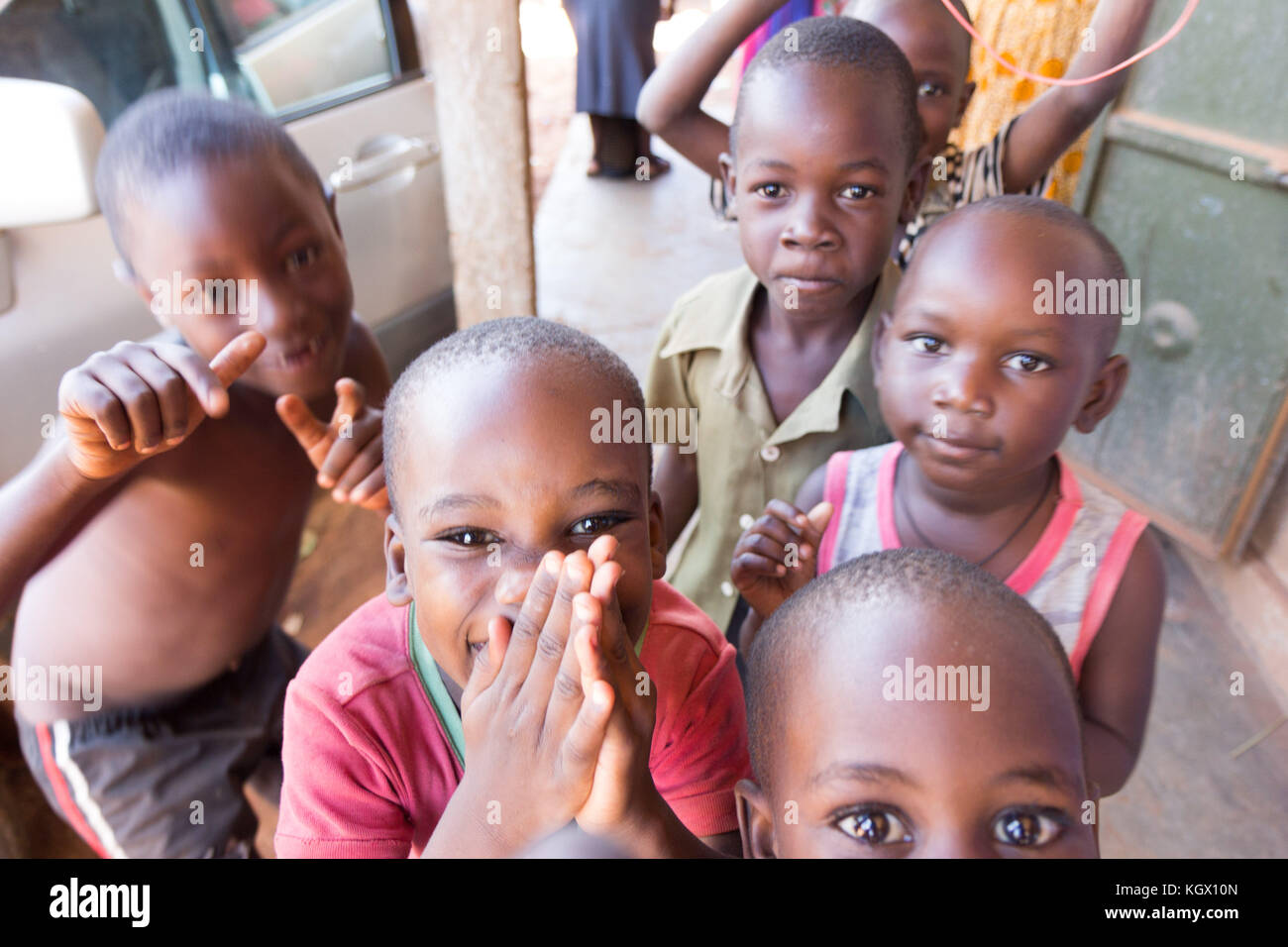 A bunch of random Ugandan children on the street laughing, smiling ...