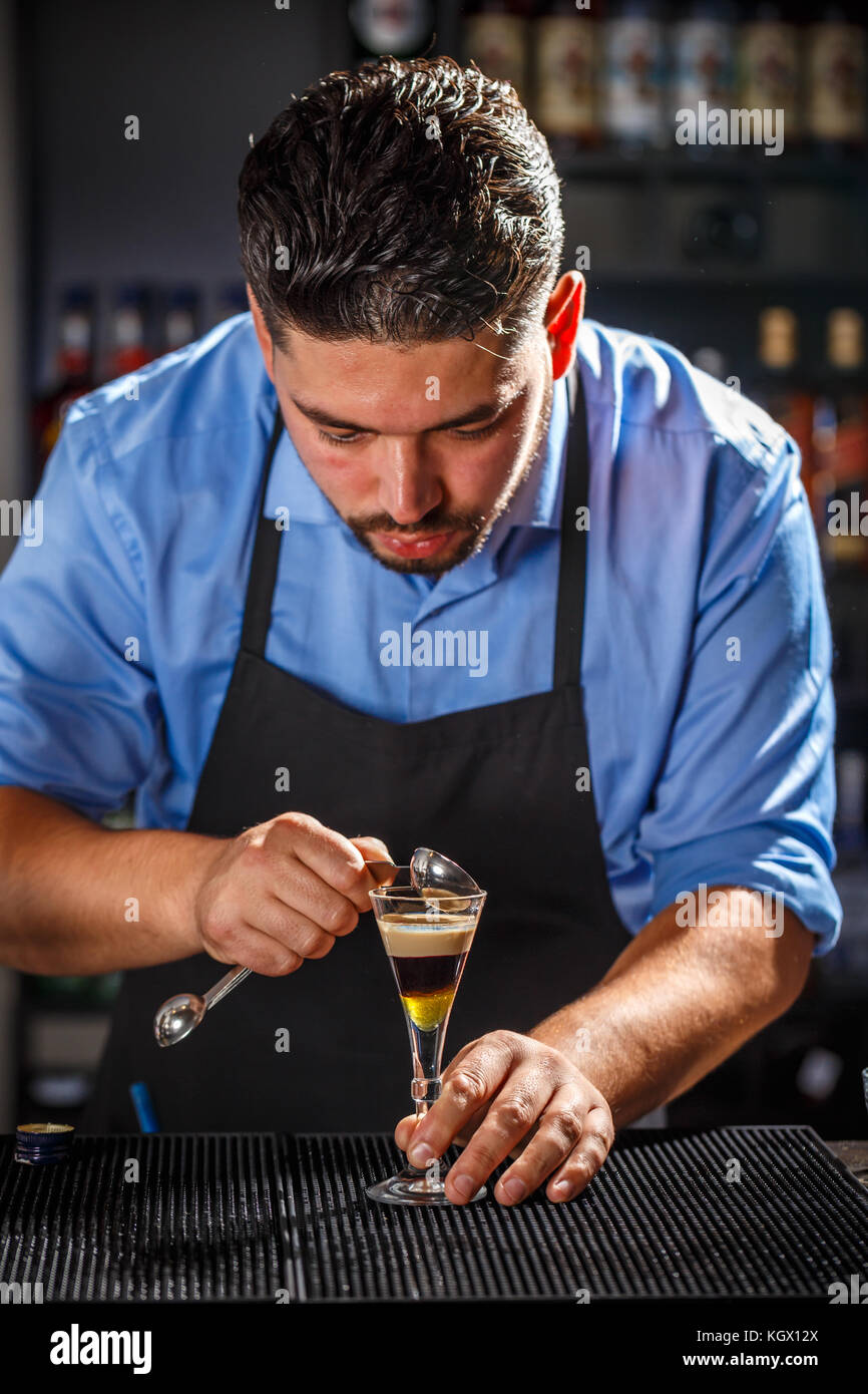 Bartender preparing layered cocktail on bar counter Stock Photo - Alamy
