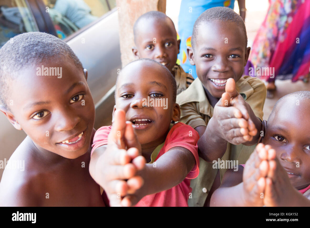 A bunch of random Ugandan children on the street laughing, smiling ...