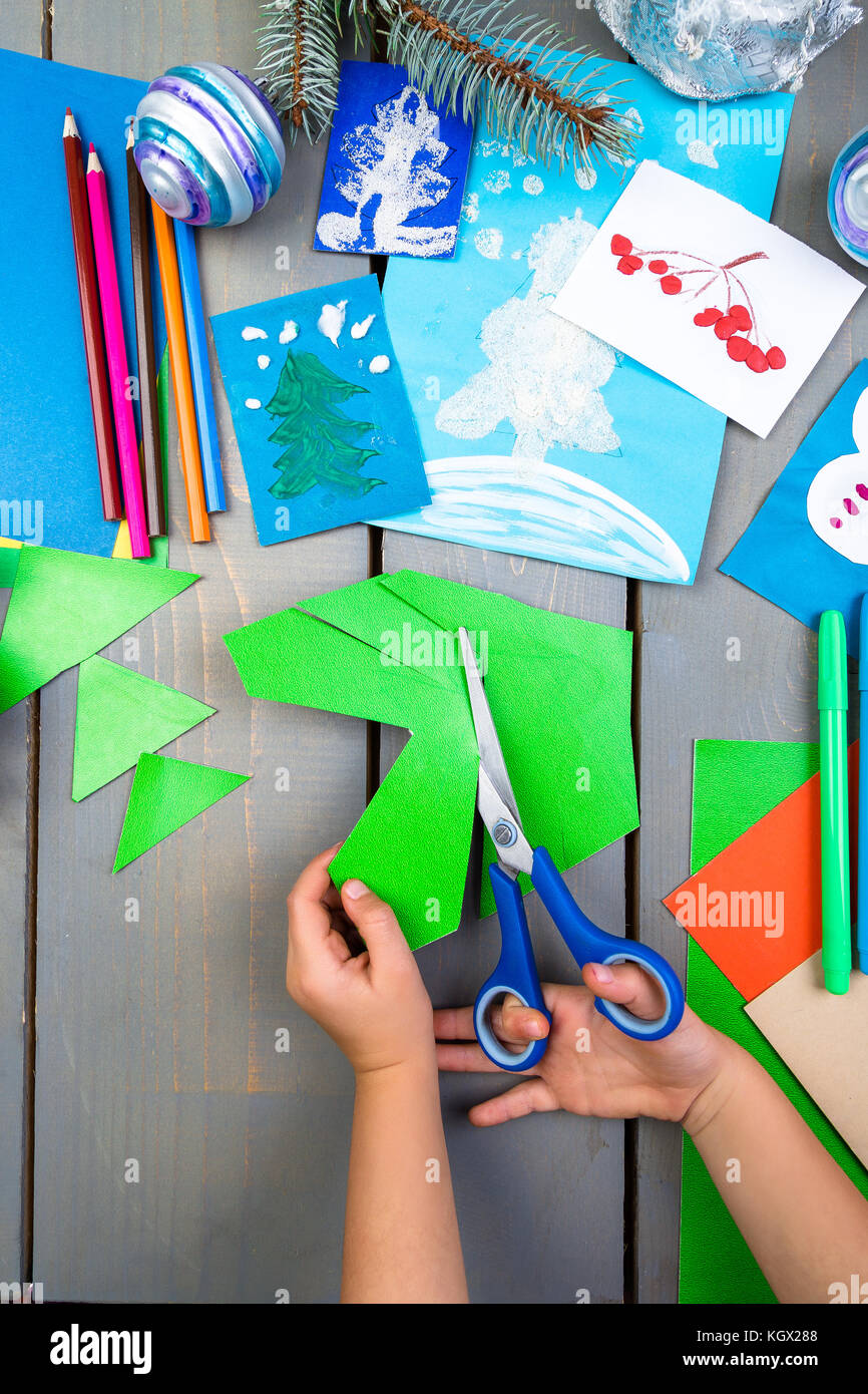 Child hands make handmade christmas toys from cardboard. Children's DIY ...