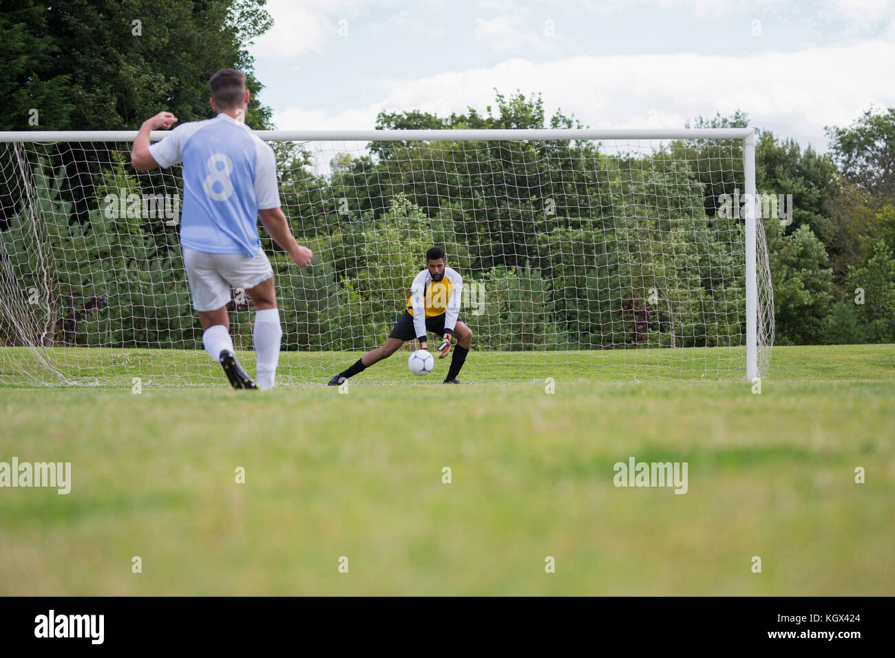 Goalkeeper saving a goal in football stadium Stock Photo - Alamy