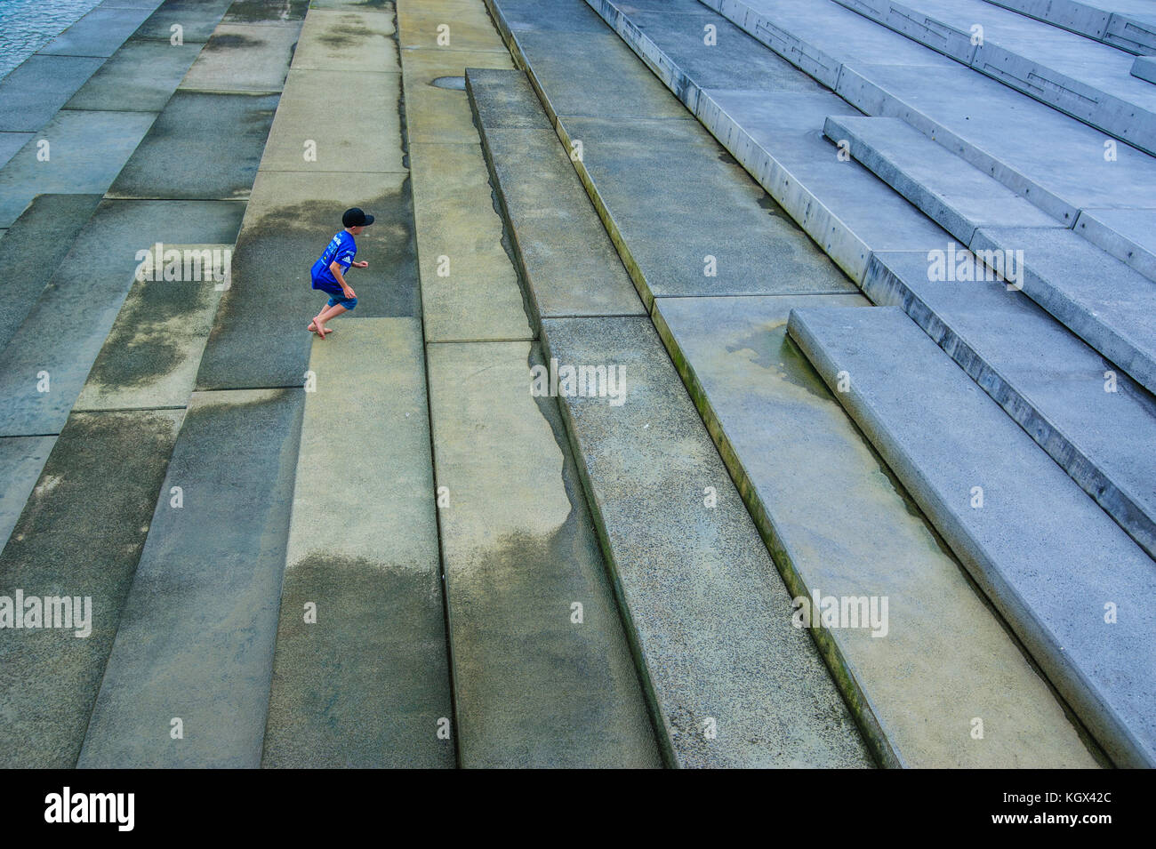 Little boy jumping up some steps, Auckland, New Zealand Stock Photo - Alamy