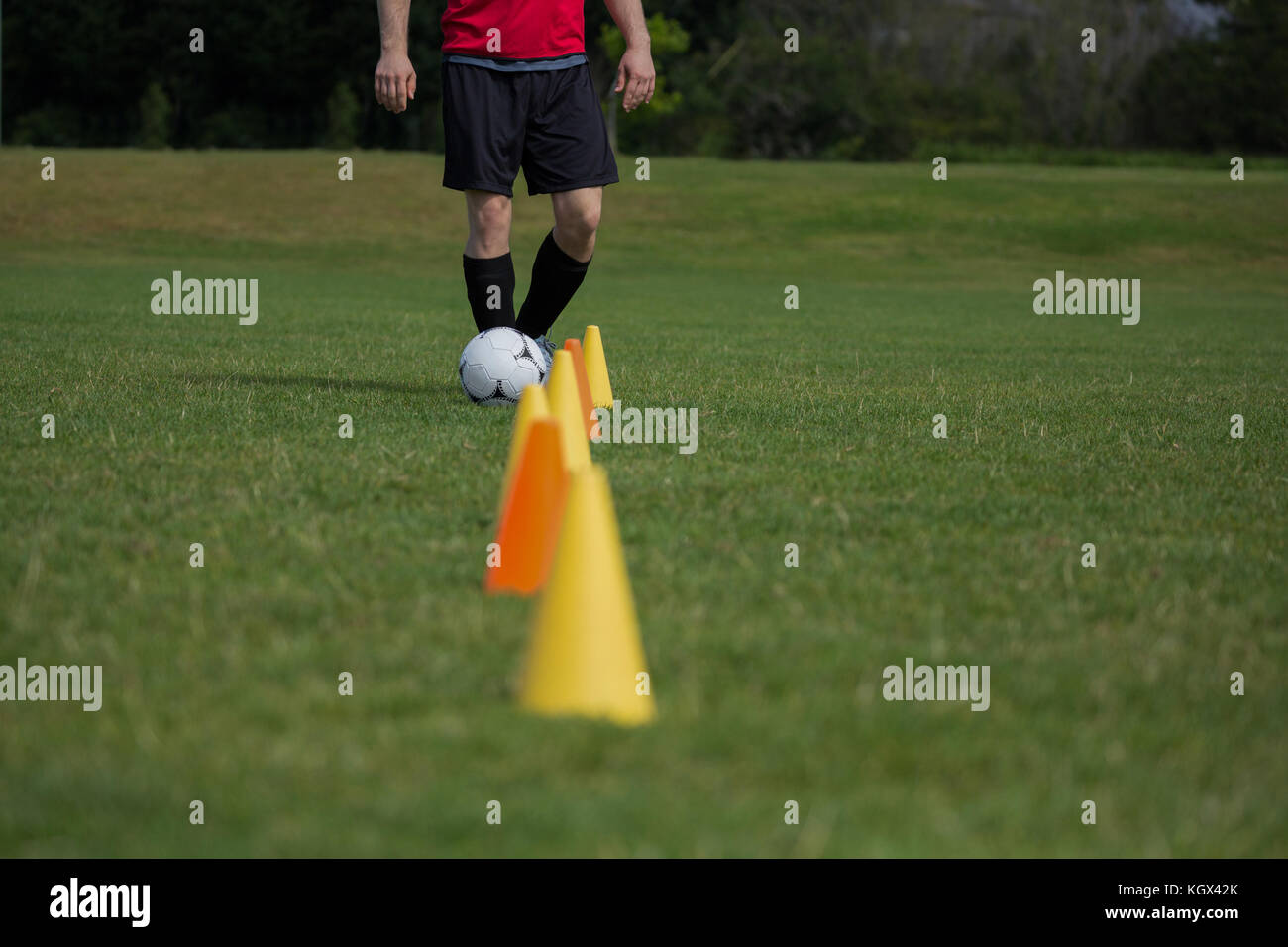 Soccer player dribbling through cones hi-res stock photography and ...