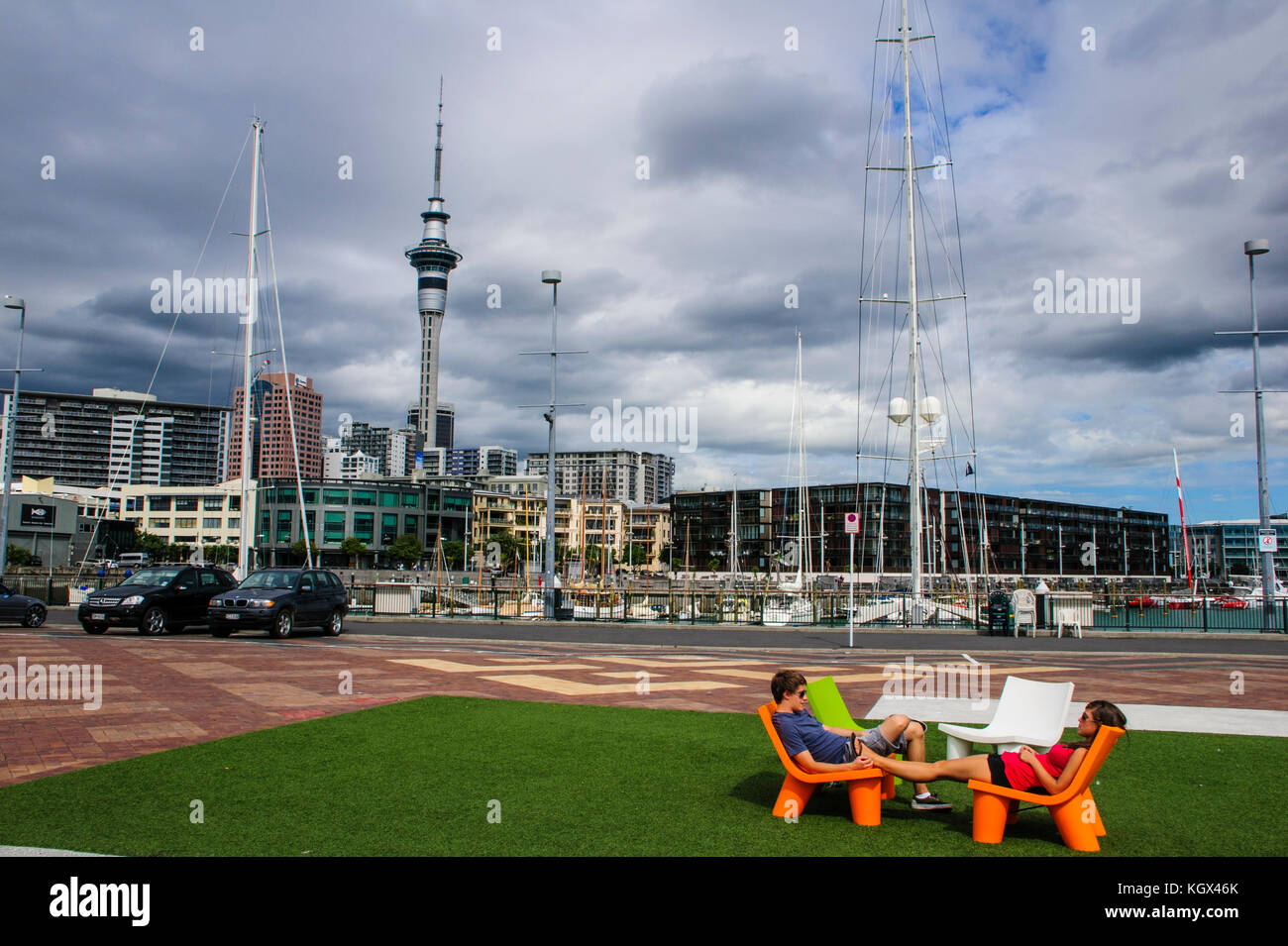 Tourists relaxing in the harbour of Auckland with the skytower, New ...