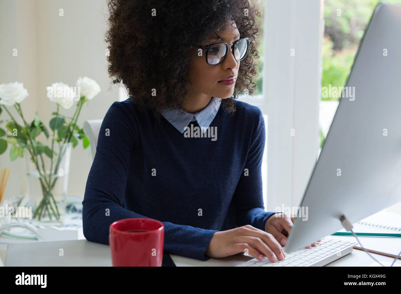 Beautiful woman working on desktop pc at desk in home Stock Photo - Alamy