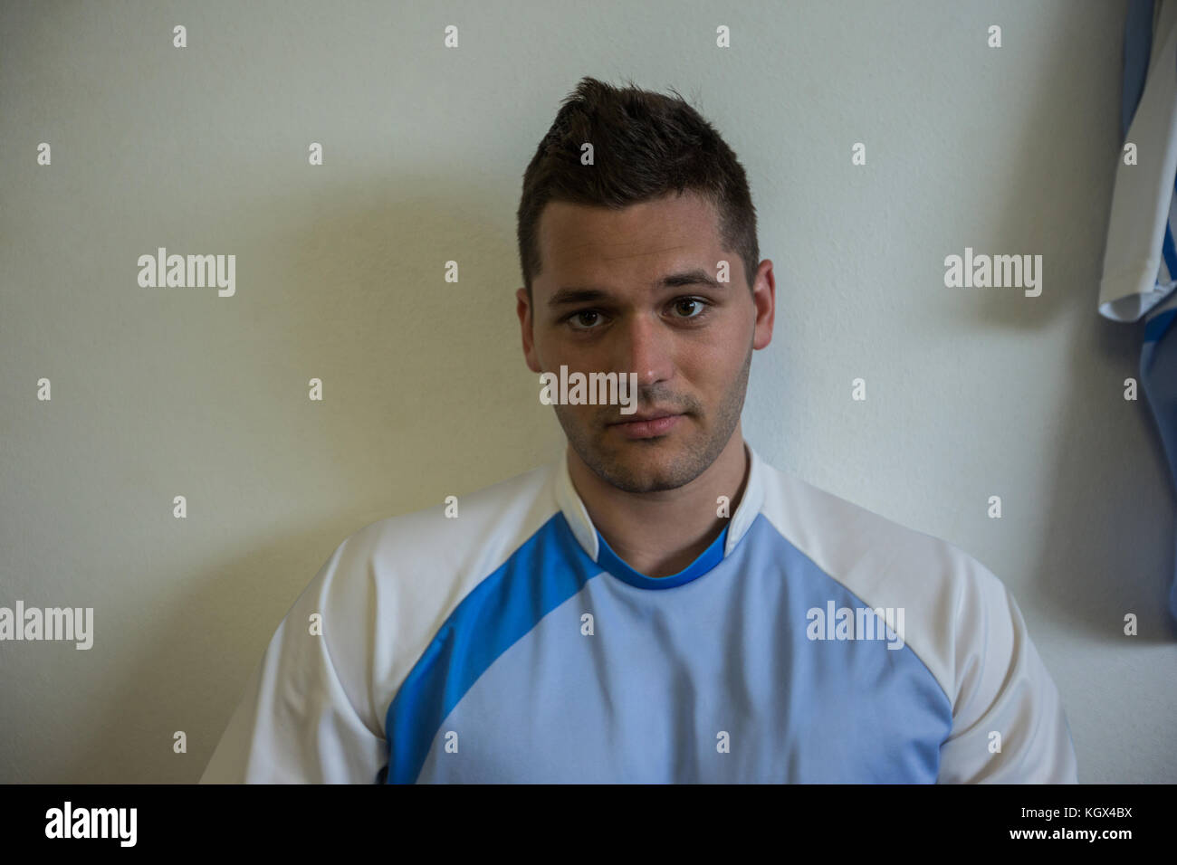 Portrait of football player relaxing in changing room Stock Photo - Alamy