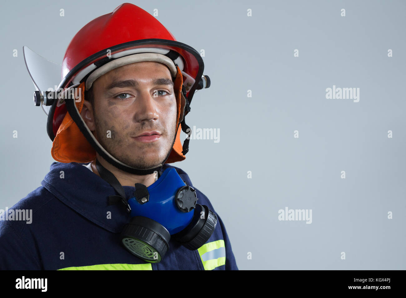 Close-up of fireman looking at camera against white background Stock ...