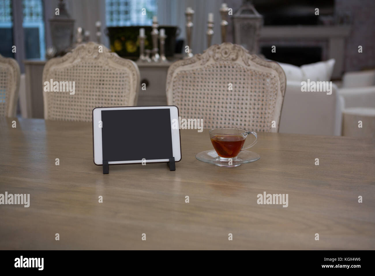 Digital tablet and lemon tea on dining table at home Stock Photo - Alamy