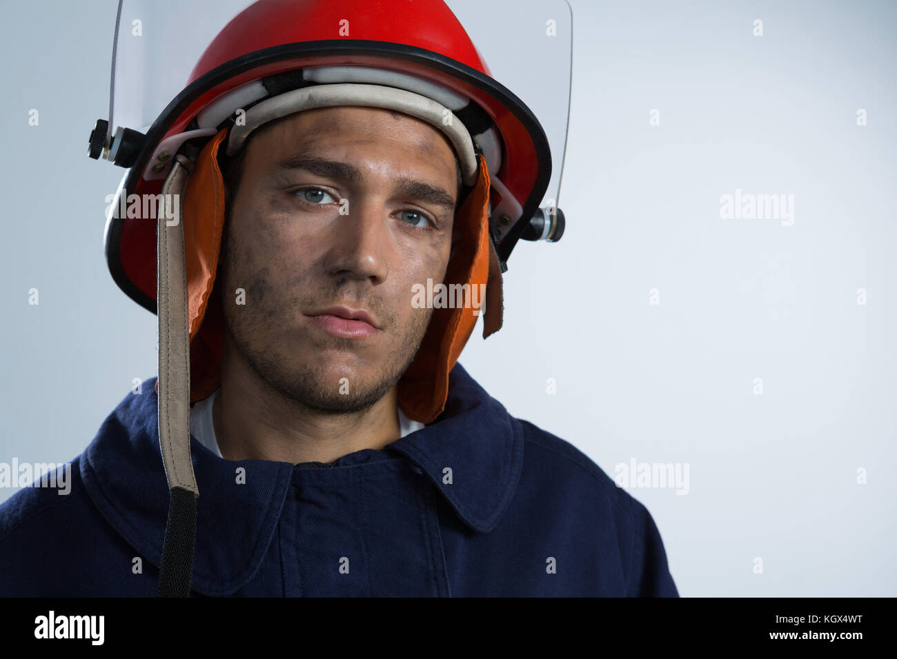 Close-up of fireman looking at camera against white background Stock ...