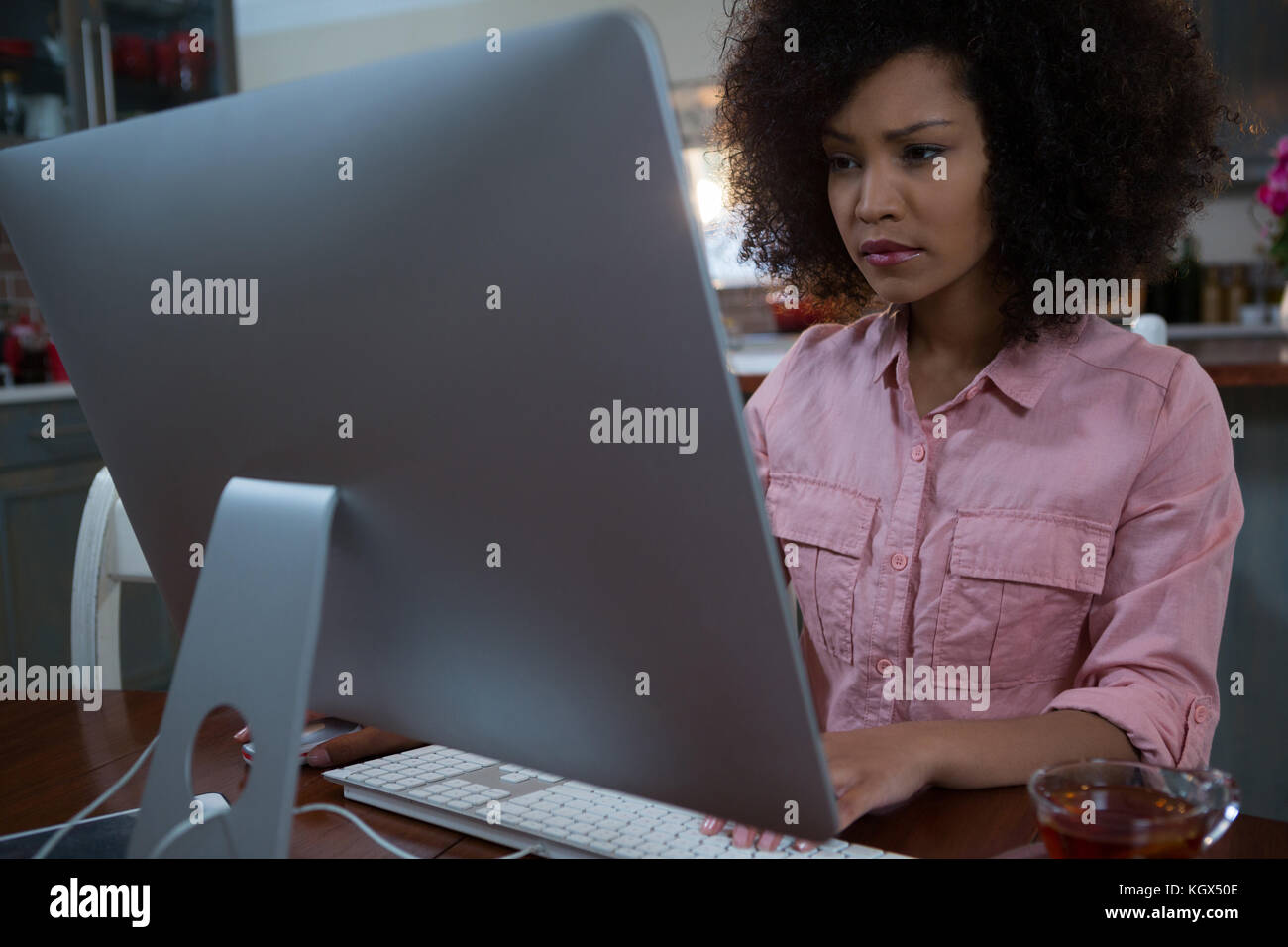 Young woman using computer at home Stock Photo - Alamy