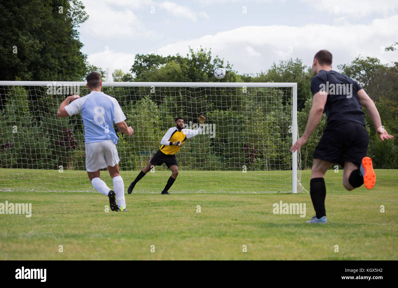Goalkeeper diving to save the goal in the ground Stock Photo - Alamy