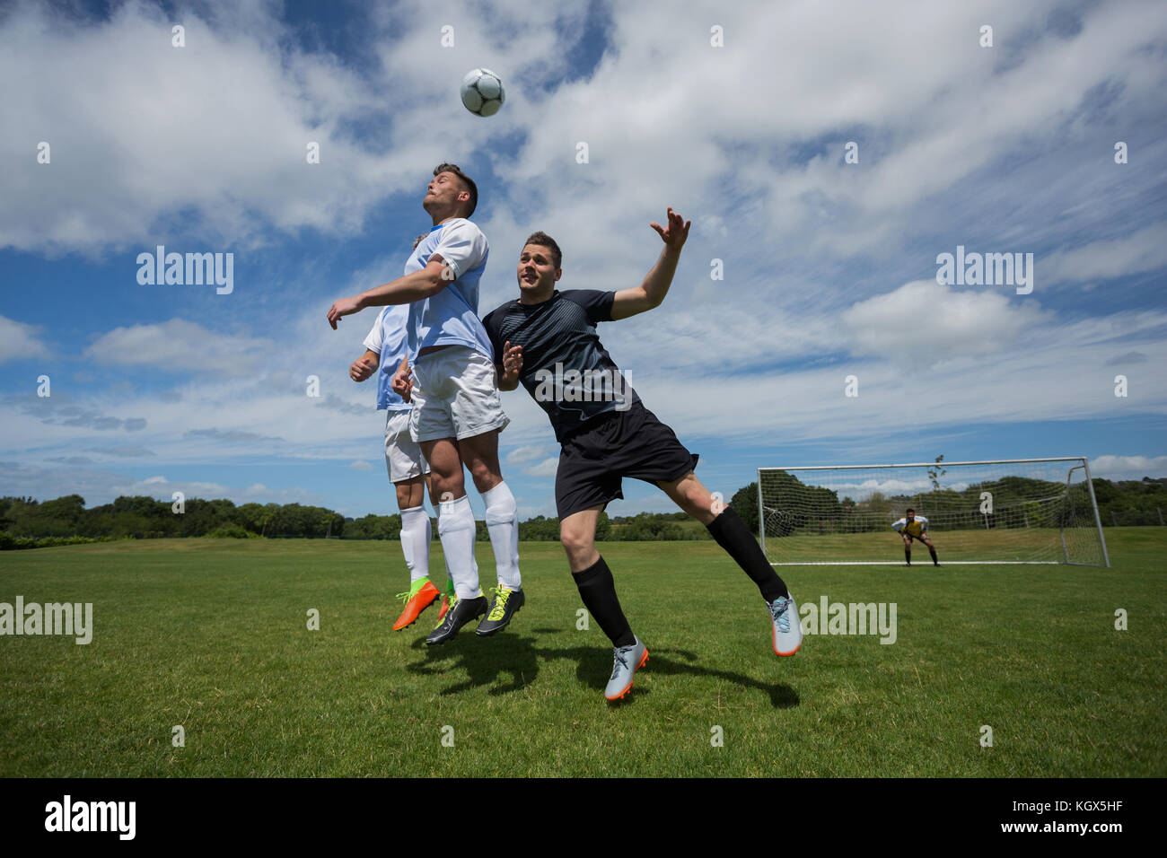 Football players playing soccer in the ground on a sunny day Stock ...