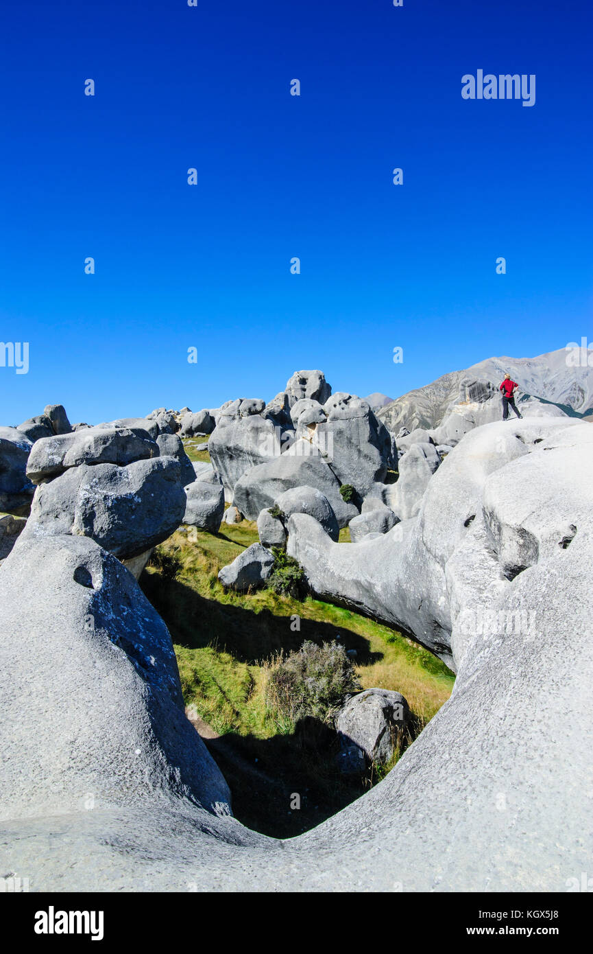 Woman standing on the Limestone outcrops of Castle Hill, South Island ...
