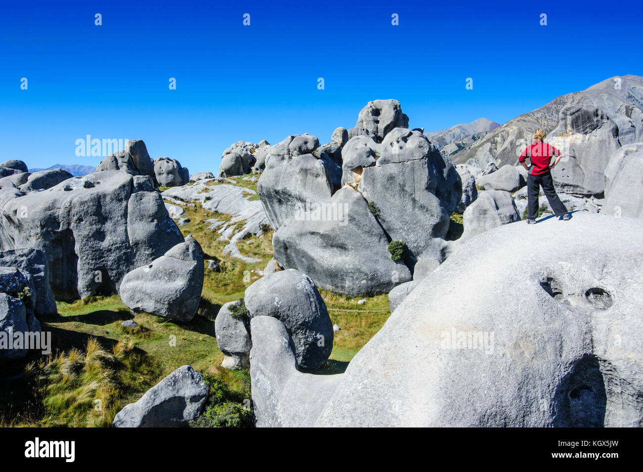 Woman standing on the Limestone outcrops of Castle Hill, South Island ...