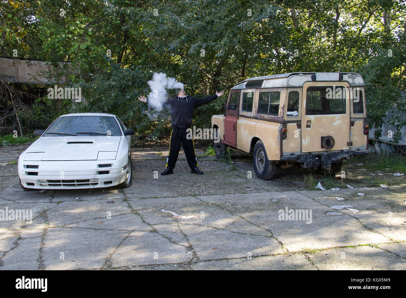 A young man, gopnik standing next to an abandoned car Stock Photo - Alamy