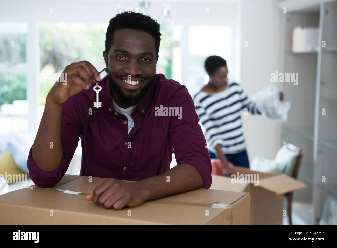 Portrait of happy man holding a key of new house Stock Photo - Alamy