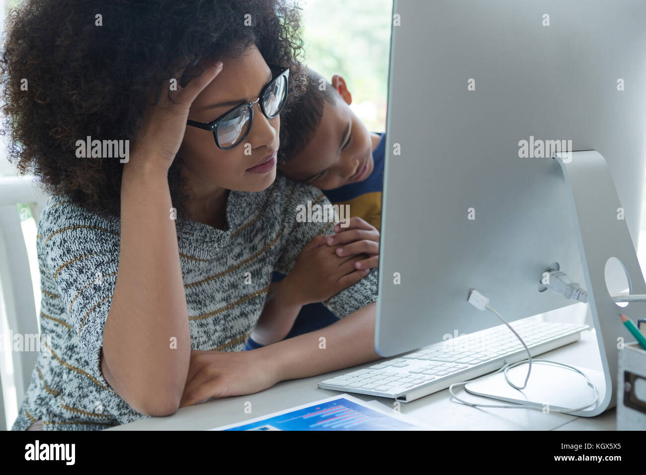 Mother with his son looking at computer at home Stock Photo - Alamy