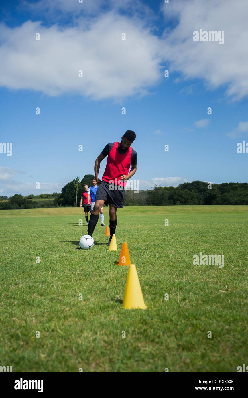 Soccer player dribbling through cones hi-res stock photography and ...