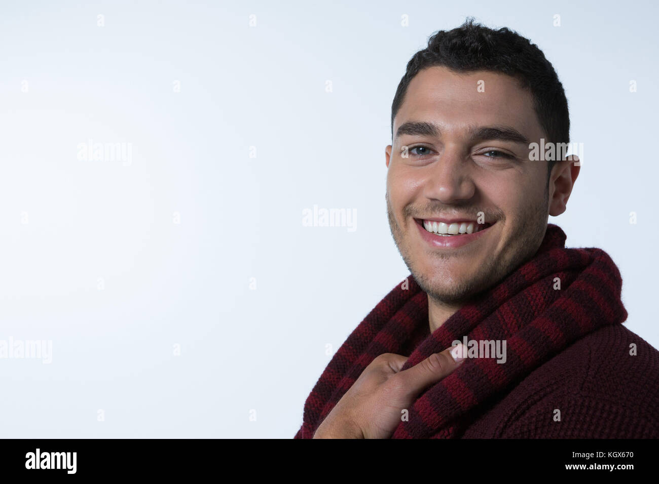 Man in warm clothing smiling at camera against white background Stock ...