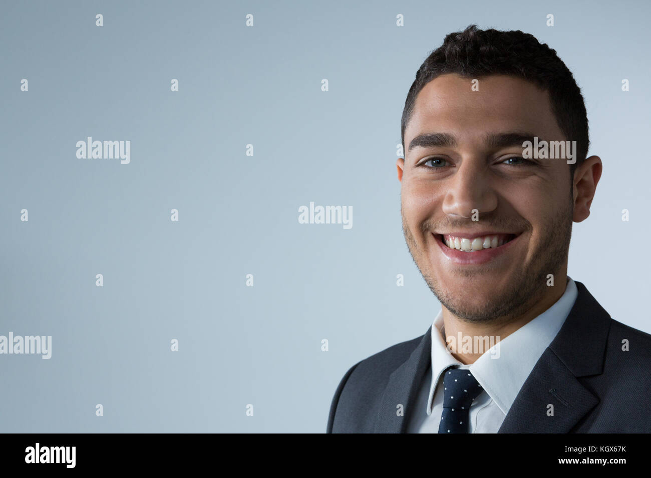 Smiling businessman standing against white background Stock Photo - Alamy