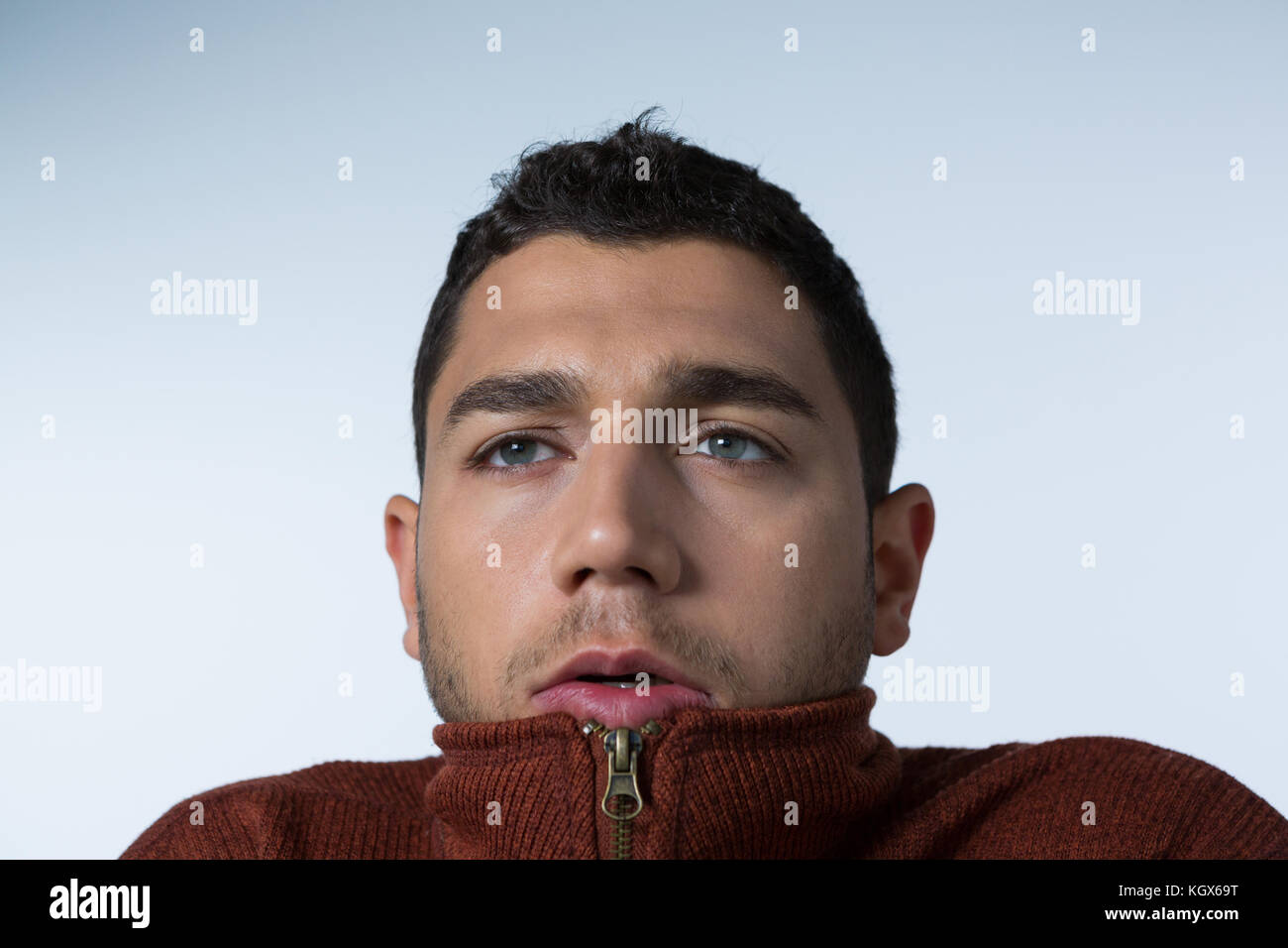 Close-up of scared man standing against white background Stock Photo ...