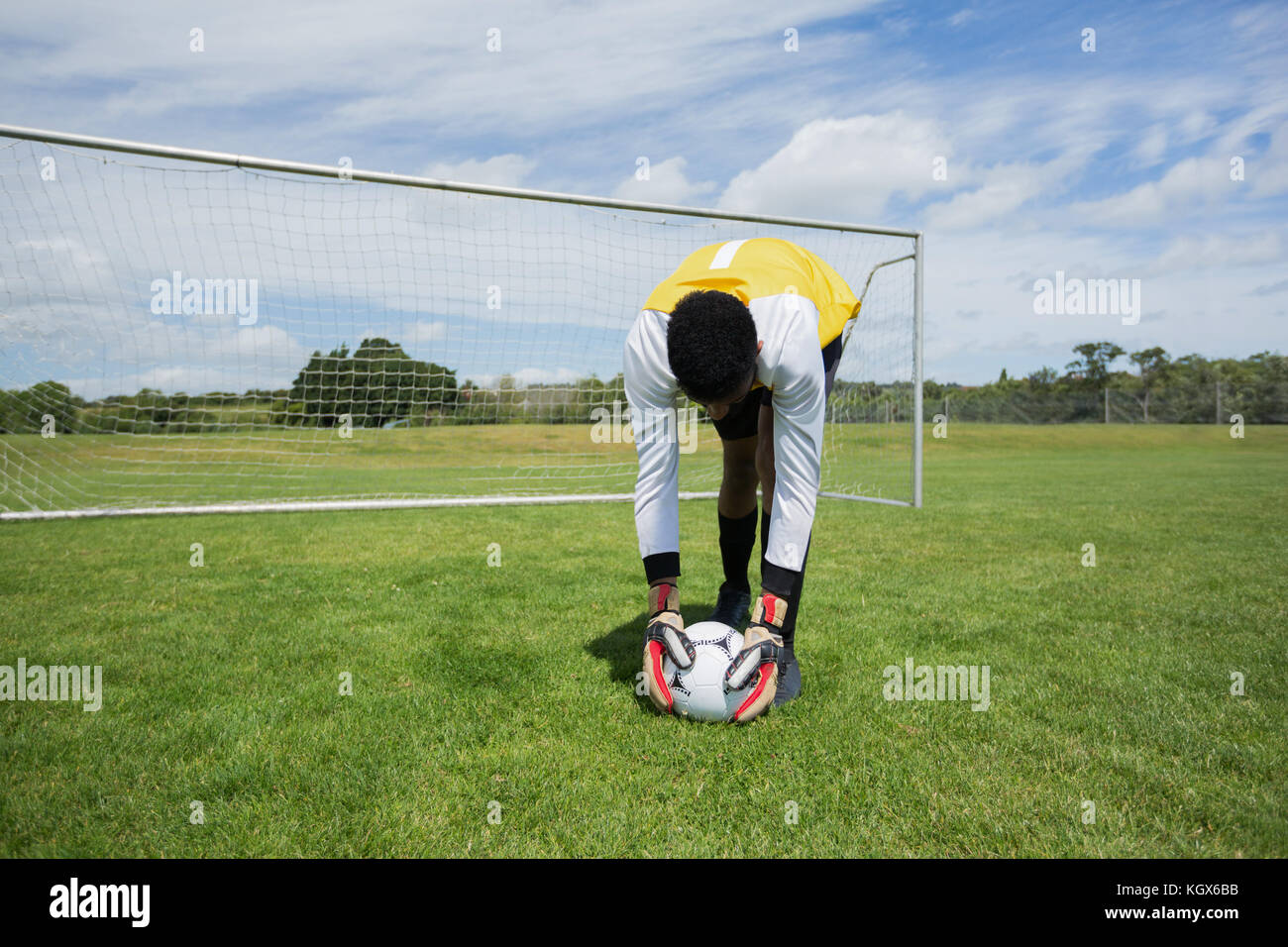 Goalkeeper ready to kick the soccer ball in the ground Stock Photo - Alamy