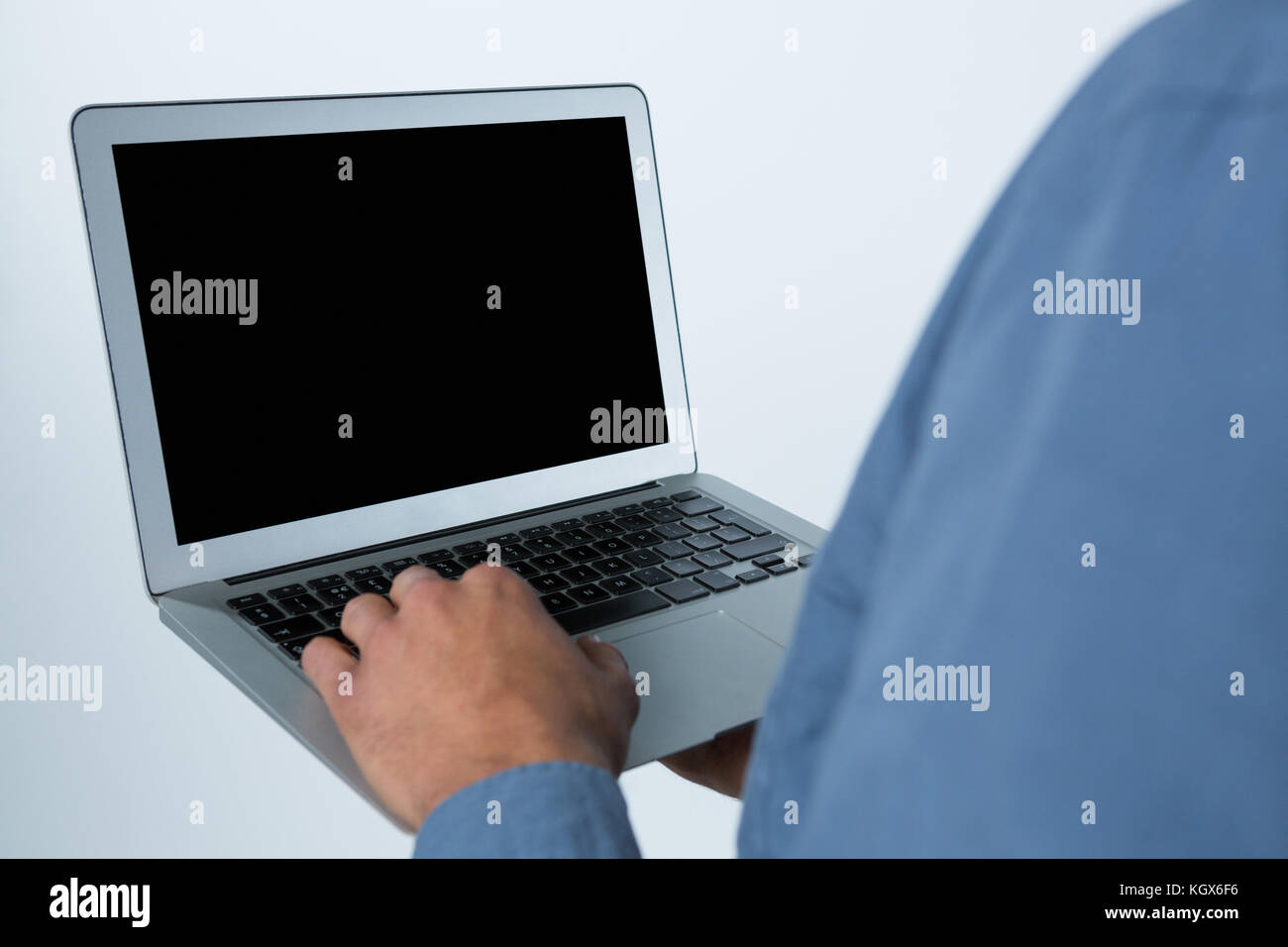 Mid section of executive using laptop against white background Stock ...